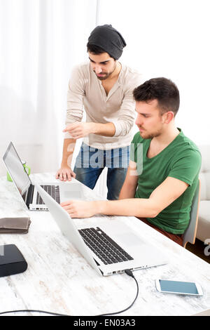Two workmates teaming up and working together Stock Photo - Alamy