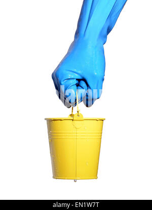 small yellow metal bucket on a soft pastel background with a bouquet of ...