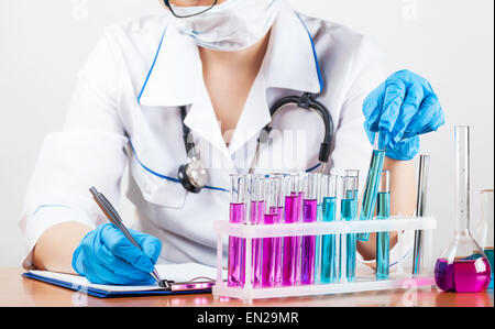 laboratorian examines the contents of the test tubes closeup Stock ...