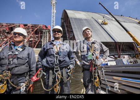 Chernobyl, Ukraine. 26th Aug, 2014. A worker walks under the huge dome ...