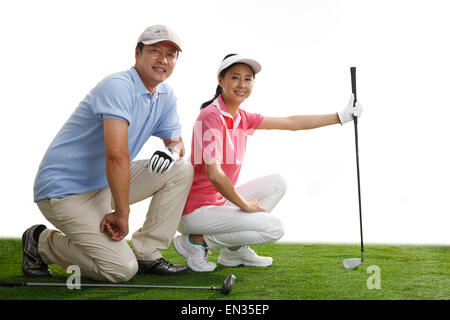 A middle-aged couple playing golf Stock Photo - Alamy