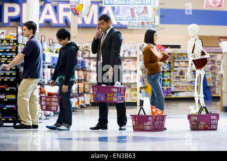 Four people and a skeleton in grocery store lineup Stock Photo - Alamy
