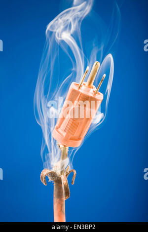Vertical shot of an electrical extension cord isolated on a blue ...