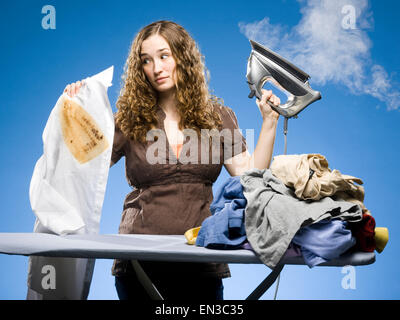 Woman ironing clothes Stock Photo - Alamy