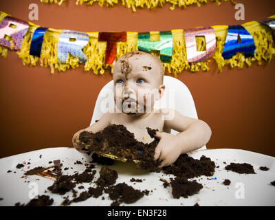 baby eating messy chocolate cake at birthday party Stock Photo - Alamy