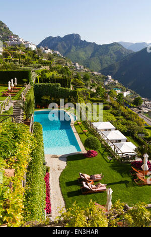 View at a terrace with a swimming pool, a sunshade and garden furniture ...