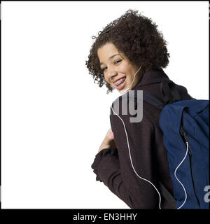 Girl with backpack and earbuds smiling with braces Stock Photo - Alamy