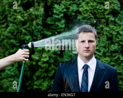man getting sprayed in the head with a hose Stock Photo - Alamy