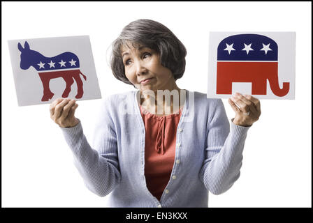woman holding up political party signs Stock Photo - Alamy