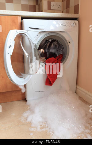 A damaged and flooded washing machine in need of repairing Stock Photo ...