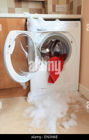 A damaged and flooded washing machine in need of repairing Stock Photo ...