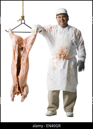 Butcher standing with hanging carcass and knife Stock Photo - Alamy