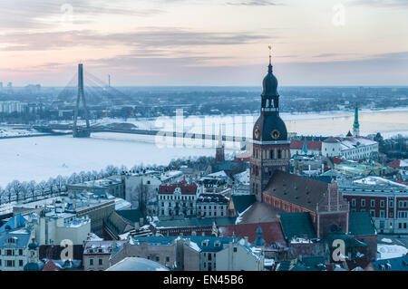 Winter cityscape of Riga. Modern architecture. Snow on road. Cloudy sky ...