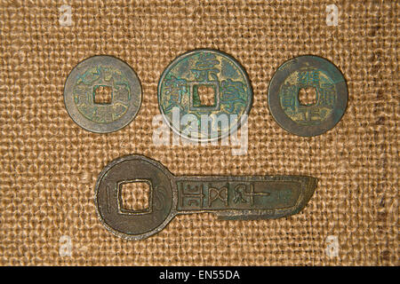 A lot antique bronze Chinese coins on old cloth Stock Photo - Alamy