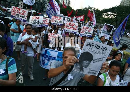 Makati, Philippines. 28th Apr, 2015. A young girl lights a candle in ...