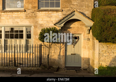 Front door and porch of typical Cotswolds cottage in village in ...