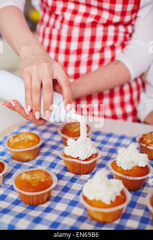 Woman decorating muffins Stock Photo - Alamy