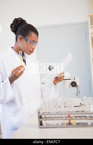 African american woman scientist reading book at laboratory Stock Photo ...