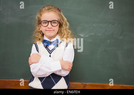 Perplex pupil looking at camera with arms crossed Stock Photo - Alamy