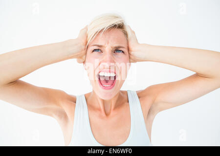 Angry blonde screaming and holding her head Stock Photo - Alamy