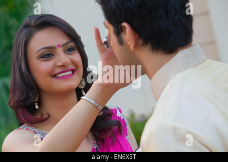 Woman putting tika on mans forehead Stock Photo - Alamy