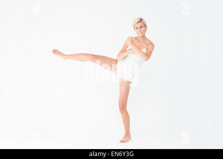 Pretty woman raising her leg Stock Photo - Alamy
