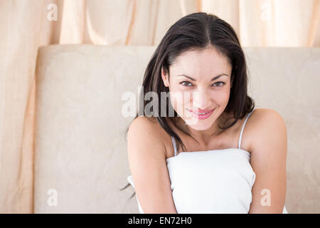 Pretty brunette smiling on bed Stock Photo - Alamy