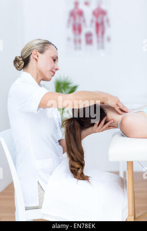 Physiotherapist doing neck massage Stock Photo - Alamy