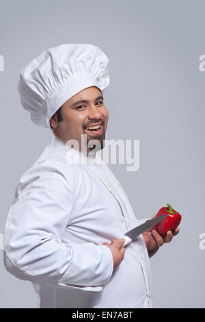 Portrait of chef with capsicum and knife Stock Photo - Alamy