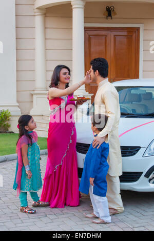 Woman putting tika on mans forehead Stock Photo - Alamy