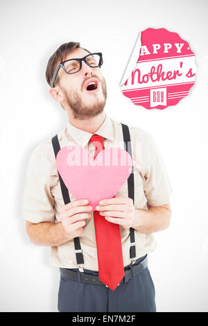 Composite image of geeky hipster crying and holding broken heart card ...