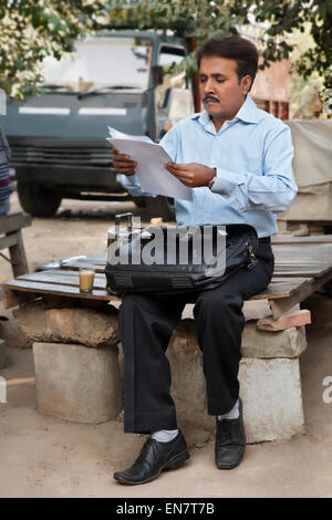 Salesman examining his paperwork Stock Photo - Alamy
