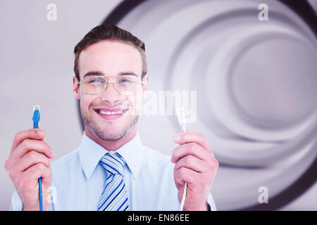 Geeky businessman holding two cables Stock Photo - Alamy