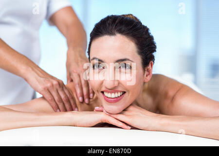 Smiling brunette getting back massage Stock Photo - Alamy