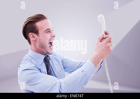 Composite image of businessman shouting at phone Stock Photo - Alamy