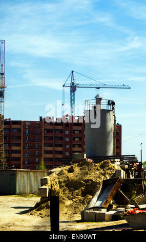 Construction site with a hopper for bulk materials and lots of sand ...