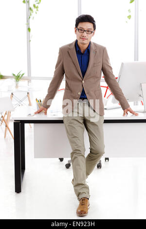 The Asian middle aged man standing on the red background Stock Photo ...