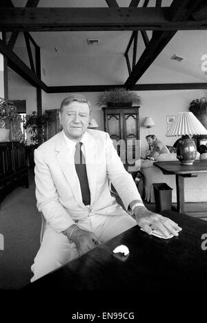 John Wayne who recently starred in 'Brannigan' at home in Texas playing ...