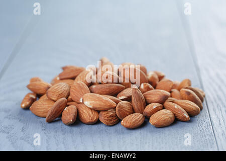 roasted almonds on blue wooden table Stock Photo - Alamy