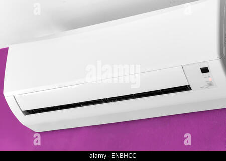 Split-system air conditioner on yellow wall Stock Photo - Alamy