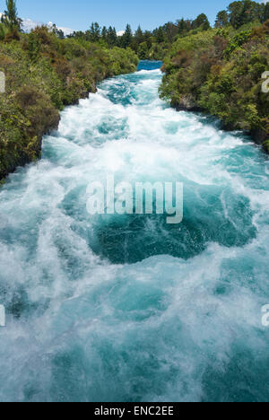 A raging river with rocks and trees on the side Stock Photo - Alamy