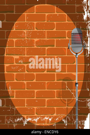 A microphone ready on stage against a brick wall Stock Photo - Alamy