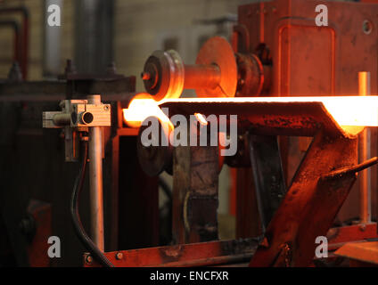 moving the heated metal rod through the rollers in rolling mill Stock ...