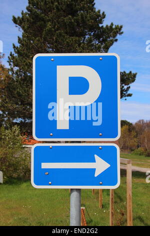 blue parking lot sign with arrow Stock Photo - Alamy