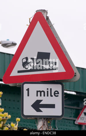 Risk of grounding triangular warning sign ahead of level crossing over ...