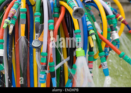 Coloured Hose pipe water fountain Stock Photo - Alamy