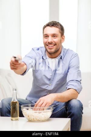 Man holding remote control and pushing the button while eating pizza ...