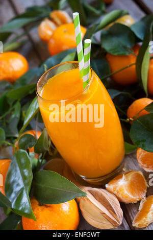 Tangerines with leaves on an old fashioned country table. Selective ...
