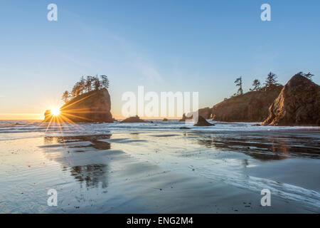 A stone image of the sun rising over the sea on a roof gable end of the ...