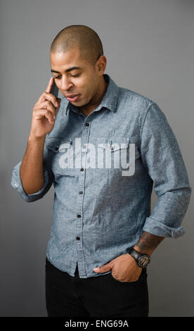 African young man standing at art studio relaxed with serious ...